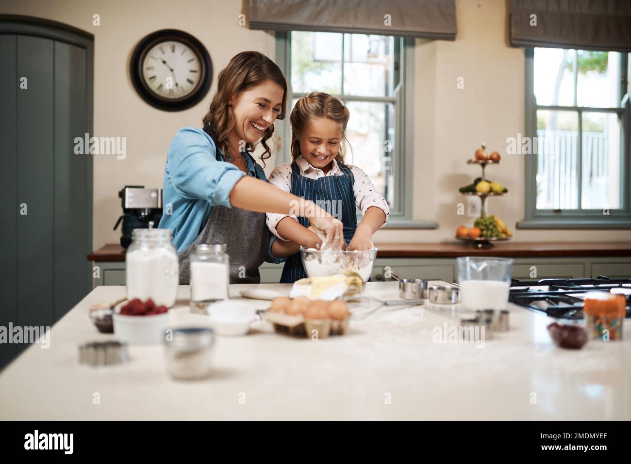 Baking keeps us happy and busy. a woman and her daughter baking ...