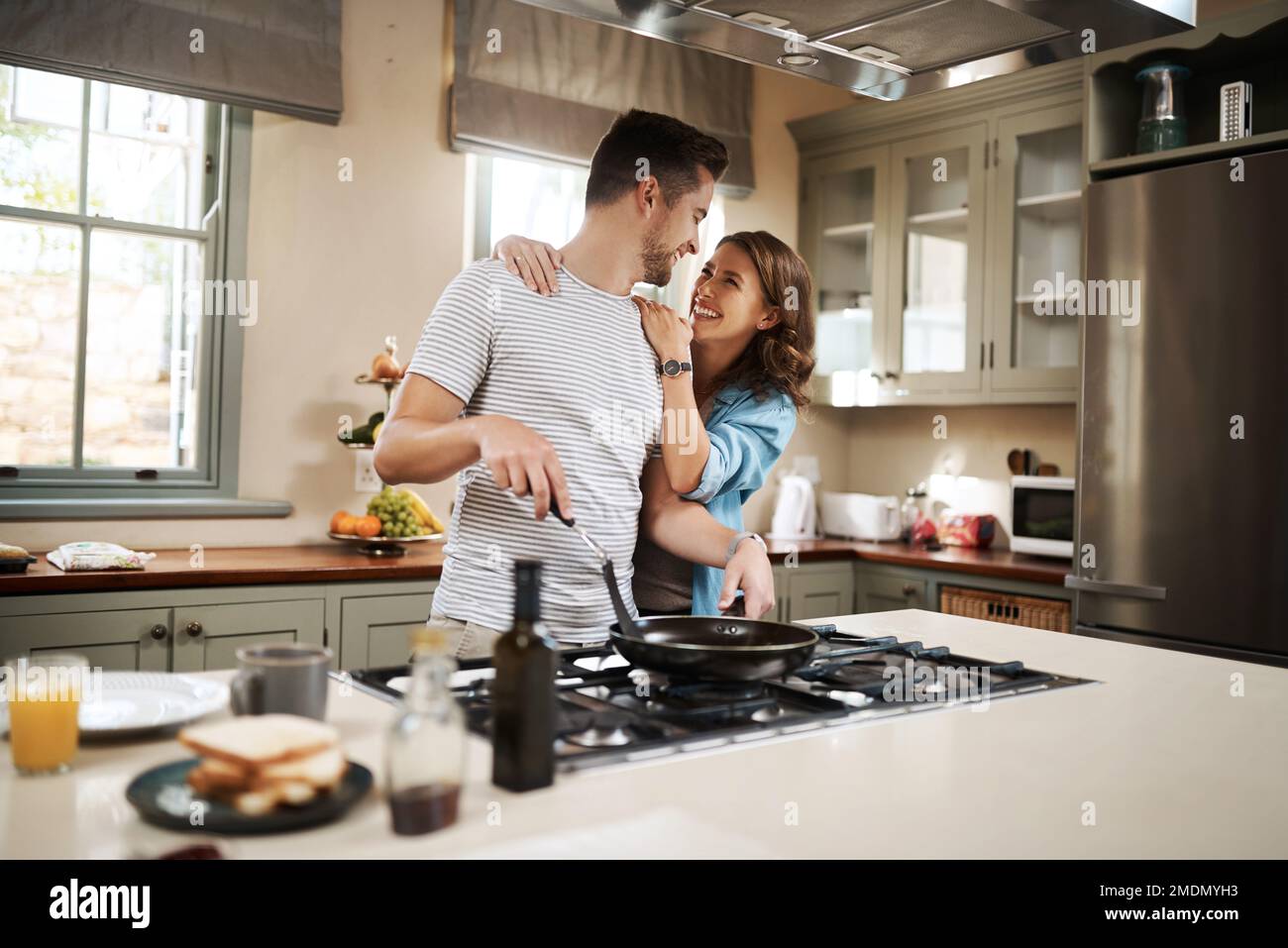 I cant wait to taste those eggs. a young woman embracing her partner ...