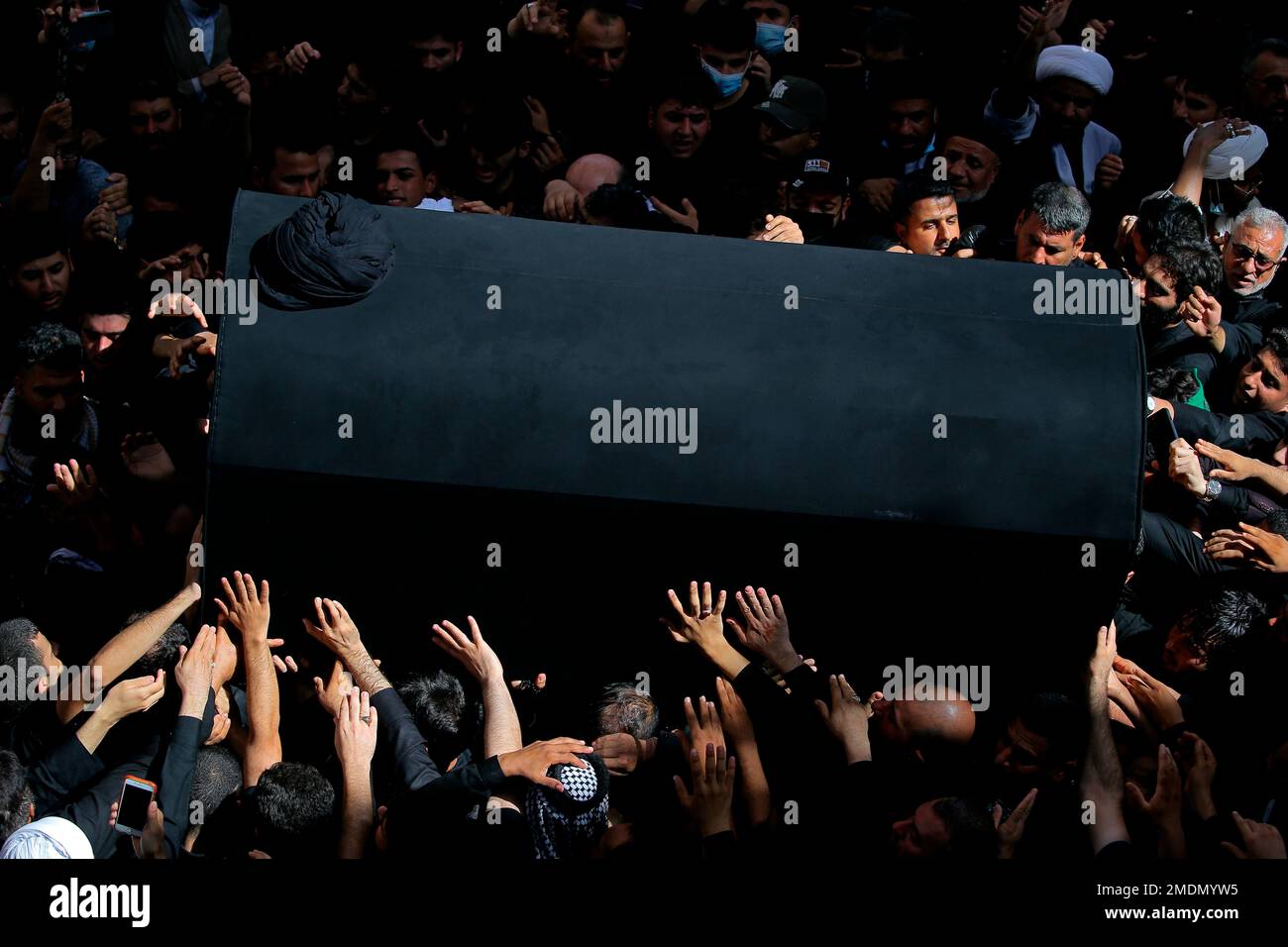 Mourners carry the coffin of Grand Ayatollah Sayyid Mohammed Saeed al ...