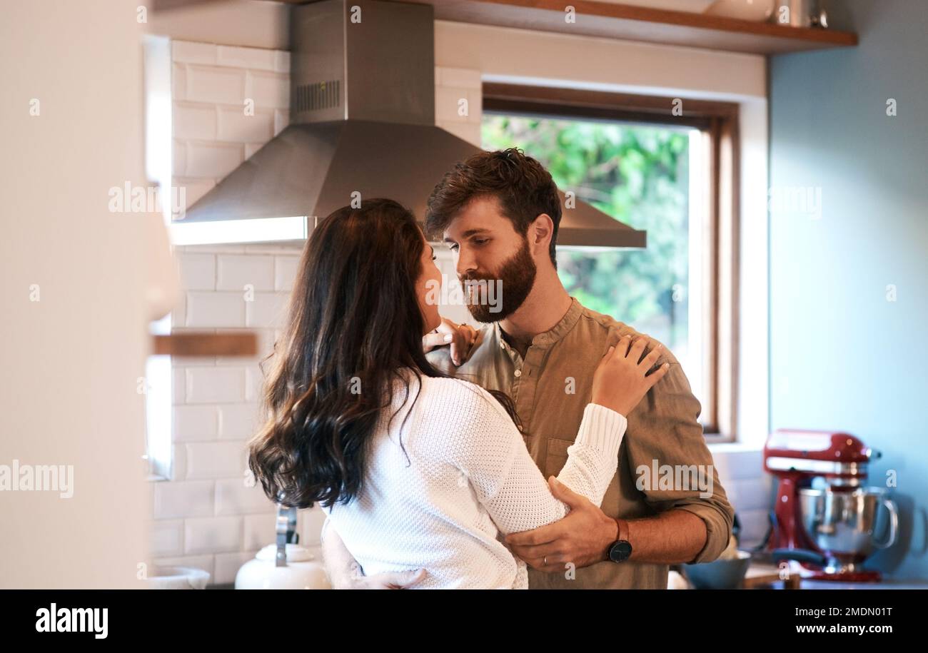 Keep the magic alive. a happy young couple dancing in the kitchen at ...
