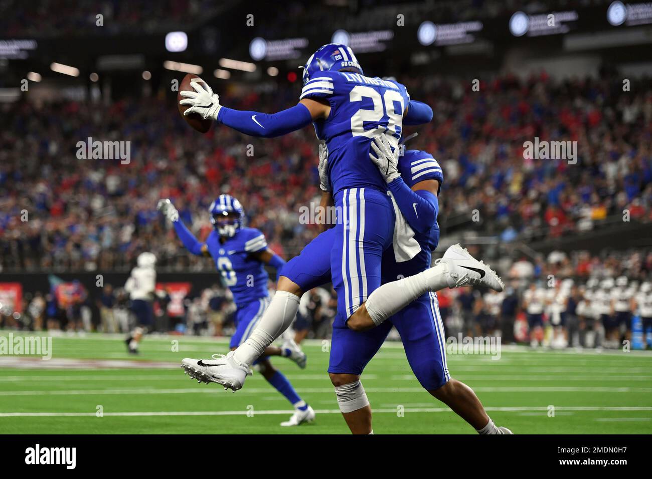 BYU defensive back Hayden Livingston (28) celebrates with a teammate ...