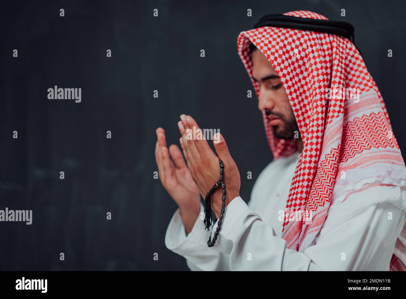 Arabian man in traditional clothes making traditional prayer to God ...