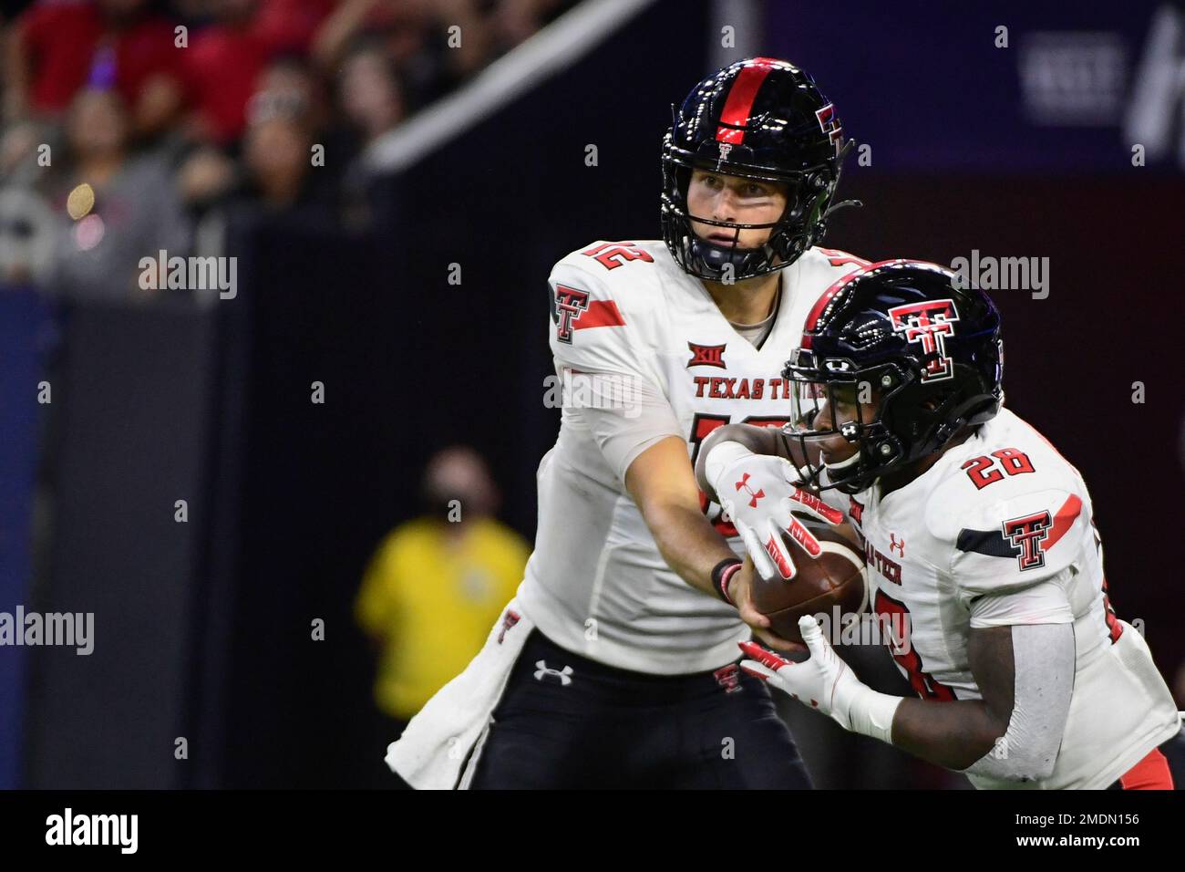 Texas Tech quarterback Tyler Shough (12) hands off the ball to running ...