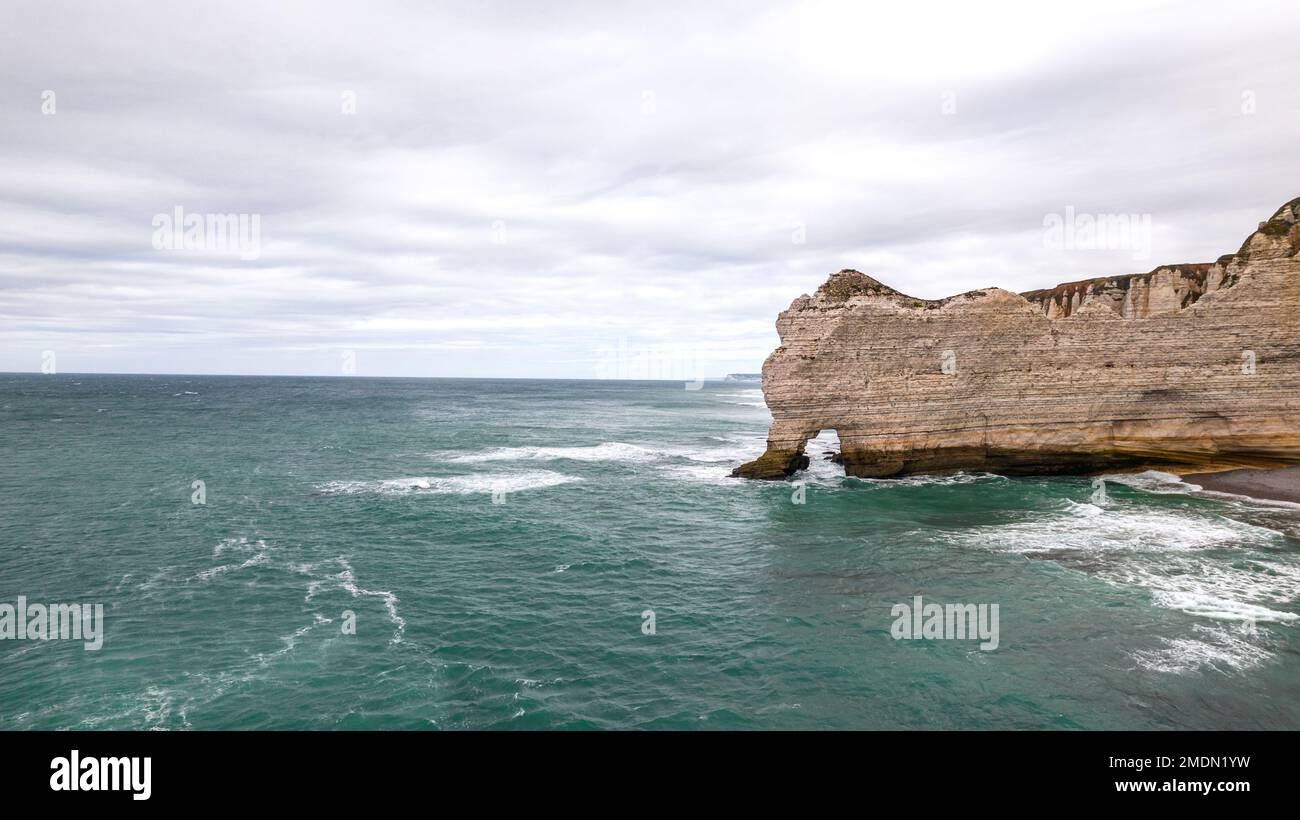 Stormy day at Etretat beach, France, showcasing the blue water and ...