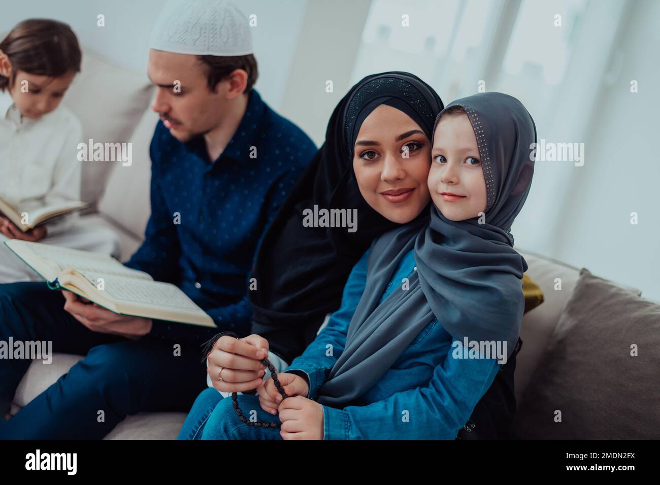 Happy Muslim family enjoying the holy month of Ramadan while praying ...