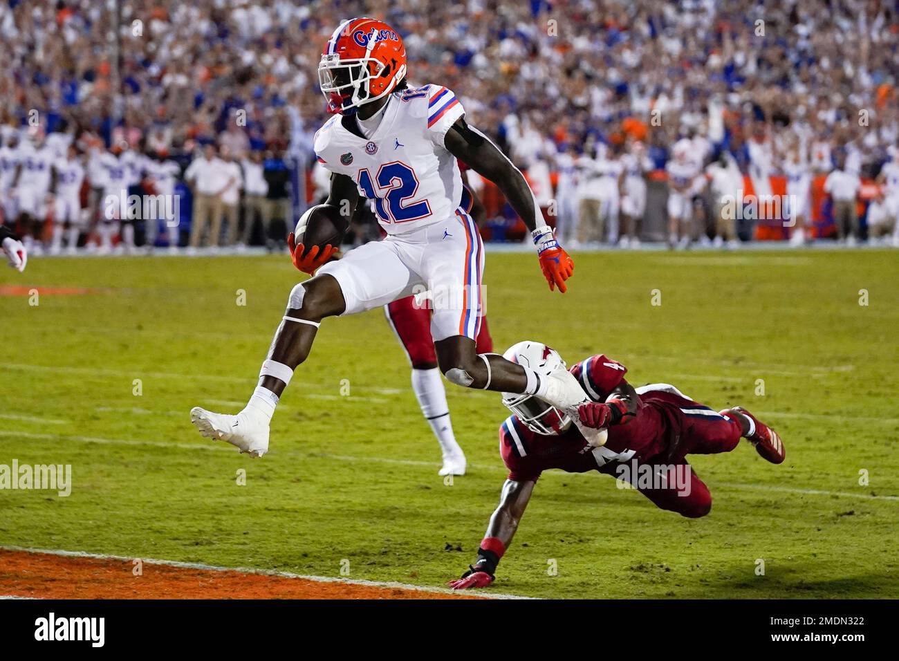 Florida wide receiver Rick Wells (12) jumps into the end zone for a ...