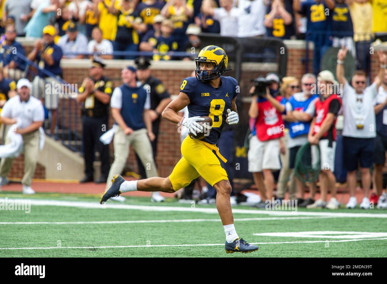 Michigan wide receiver Ronnie Bell (8) looks backward as he completes a ...
