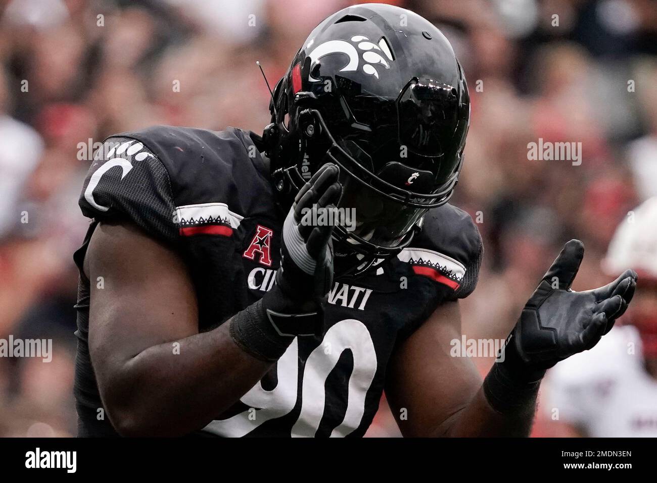 Cincinnati defensive lineman Jabari Taylor (90) reacts after sacking ...