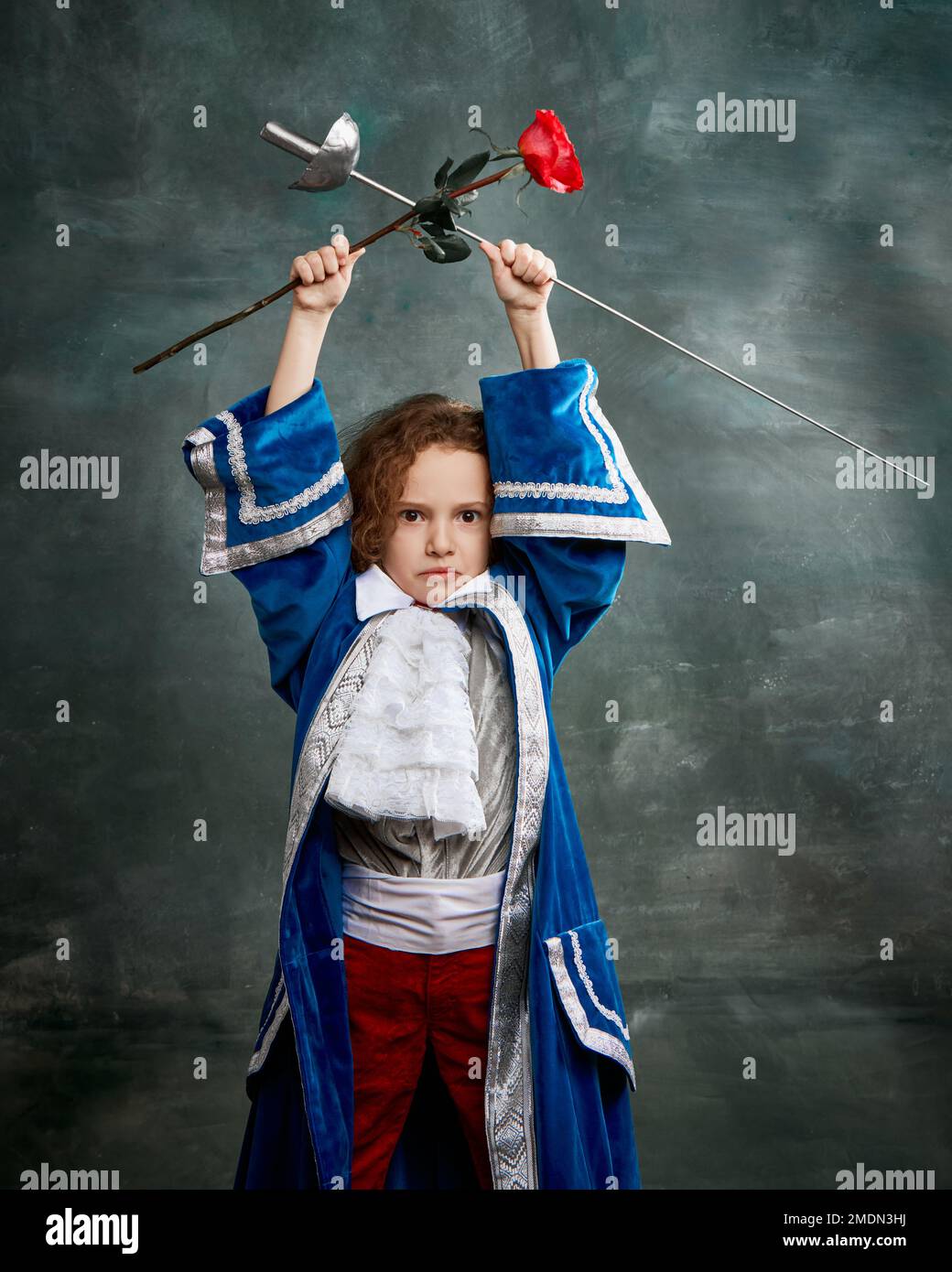 Emotional kid, little girl wearing costume of prince, musketeer and ...