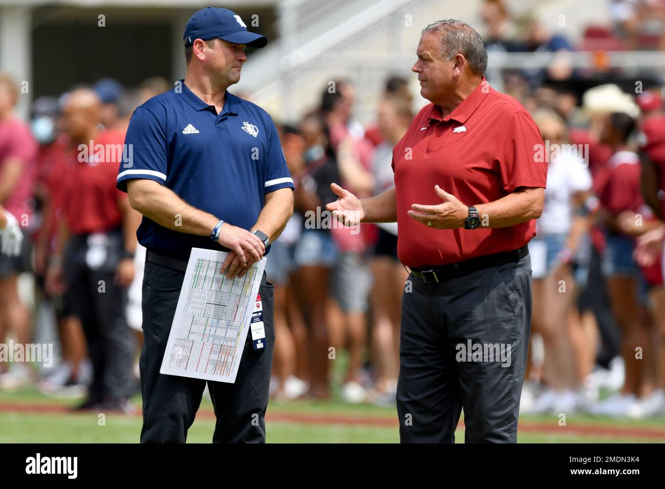 Rice coach Mike Bloomgren, left, and Arkansas coach Sam Pittman talk ...