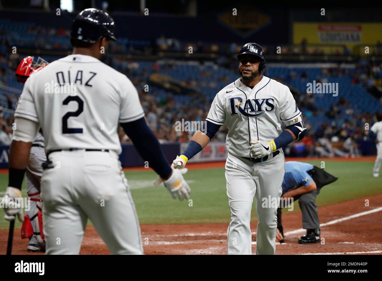 Tampa Bay Rays' Nelson Cruz, right, crosses home plate after hitting a ...
