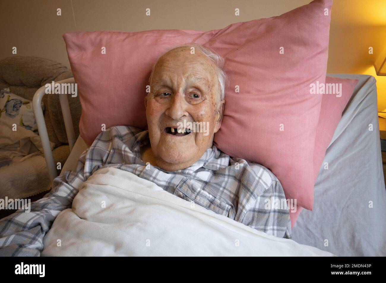 89 year-old man lying in his bed, whilst living at a care home in ...