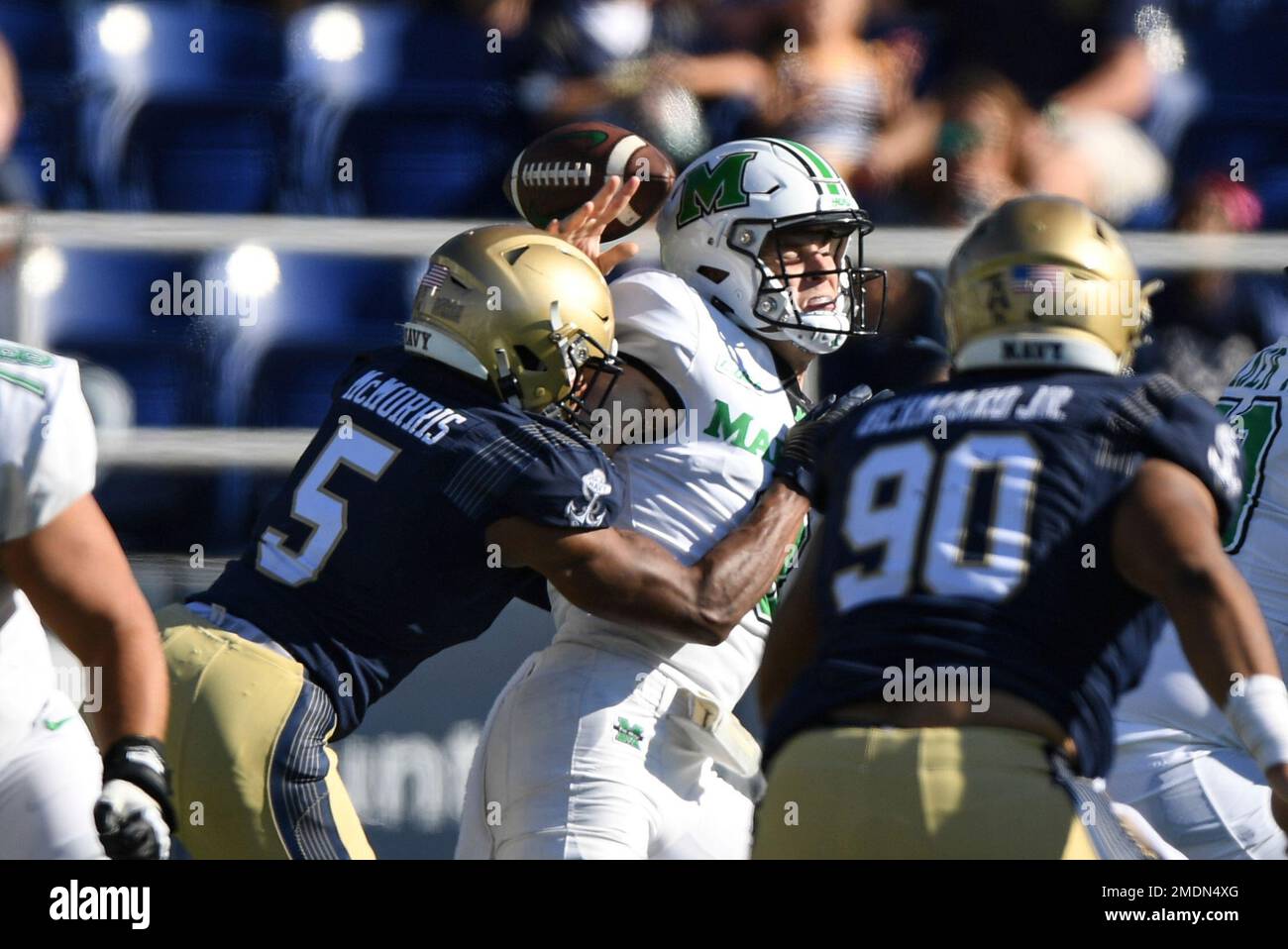 Marshall quarterback Grant Wells is sacked by Navy cornerback Michael ...