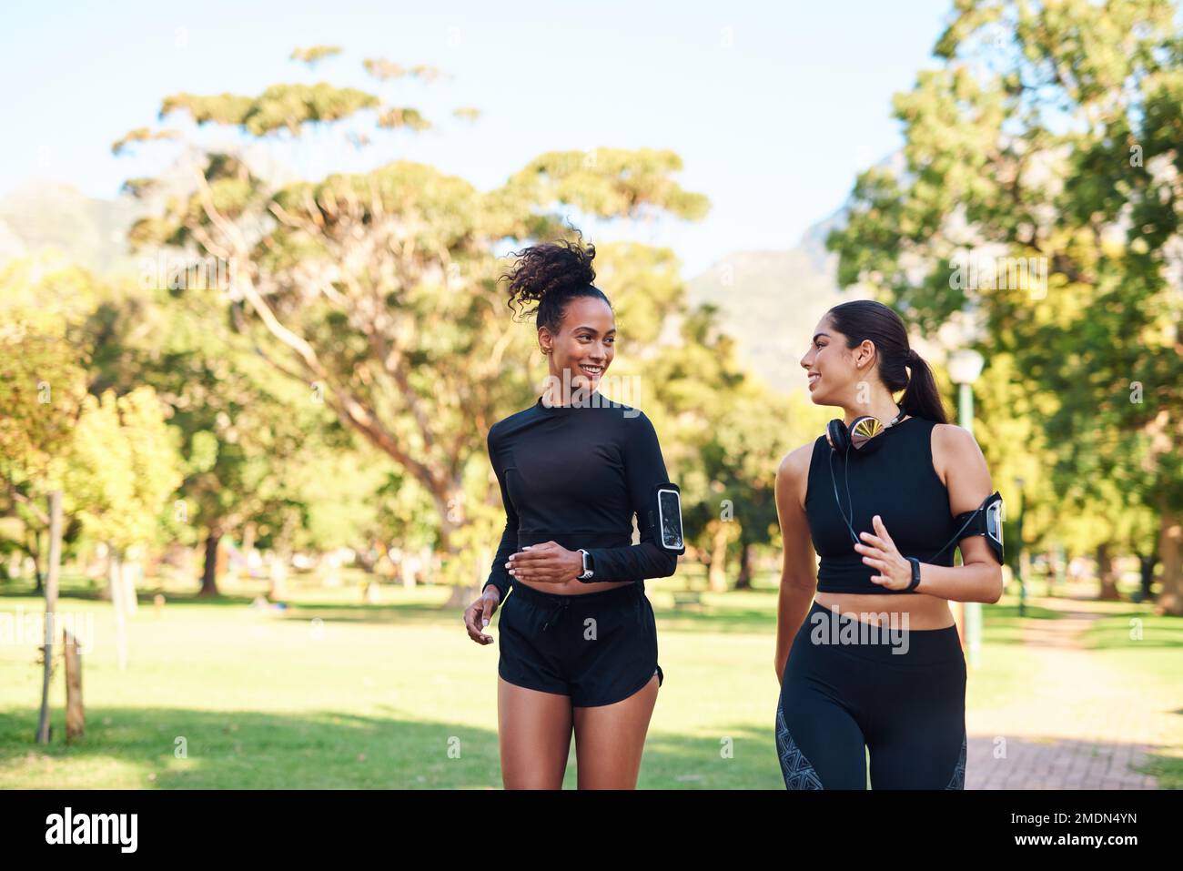 Running buddies. two attractive young women running next to each other ...