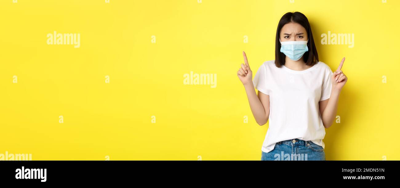 Covid-19, pandemic and social distancing concept. Disappointed asian ...