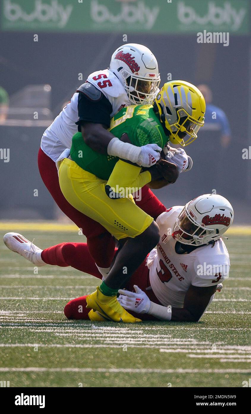 Oregon quarterback Anthony Brown (13) is wrapped up by Fresno State ...