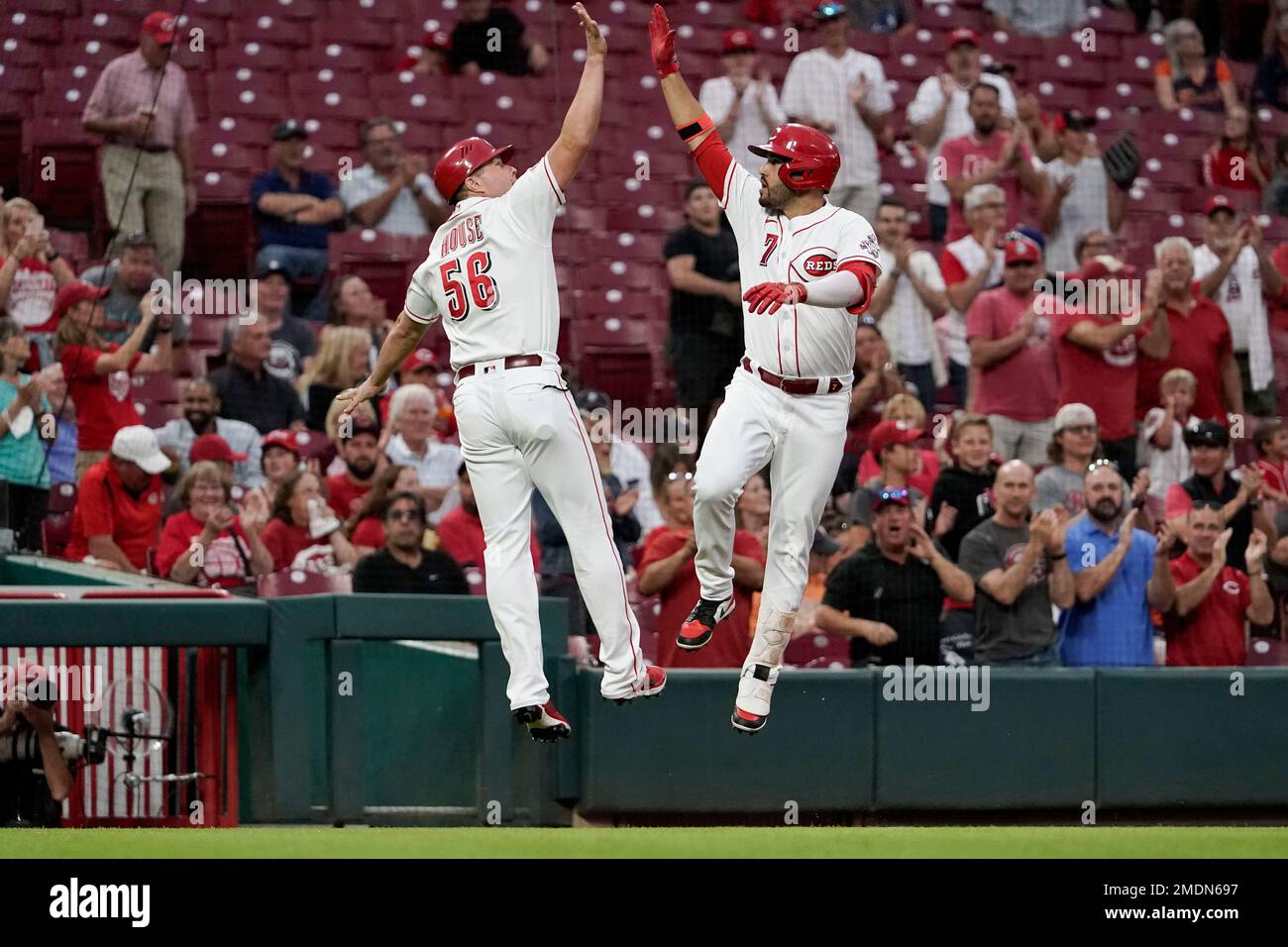 Cincinnati Reds' Eugenio Suarez (7) celebrates with third base coach J ...