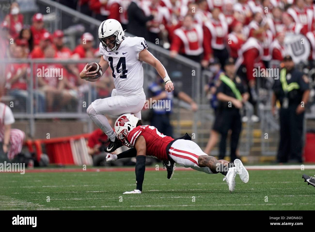 Penn State quarterback Sean Clifford (14) evades Wisconsin cornerback ...