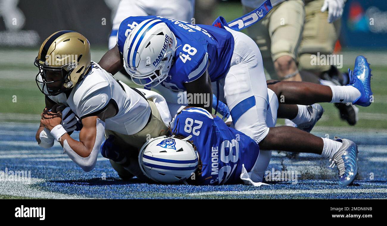 Army quarterback Christian Anderson, left, is tackled by Georgia State ...
