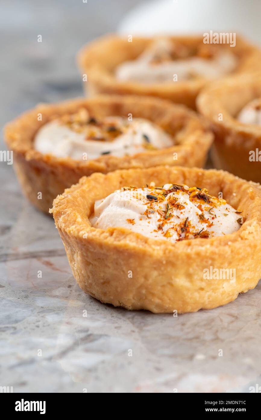 Tartlets with chicken, boiled eggs, spices and herbs. Traditional cold ...