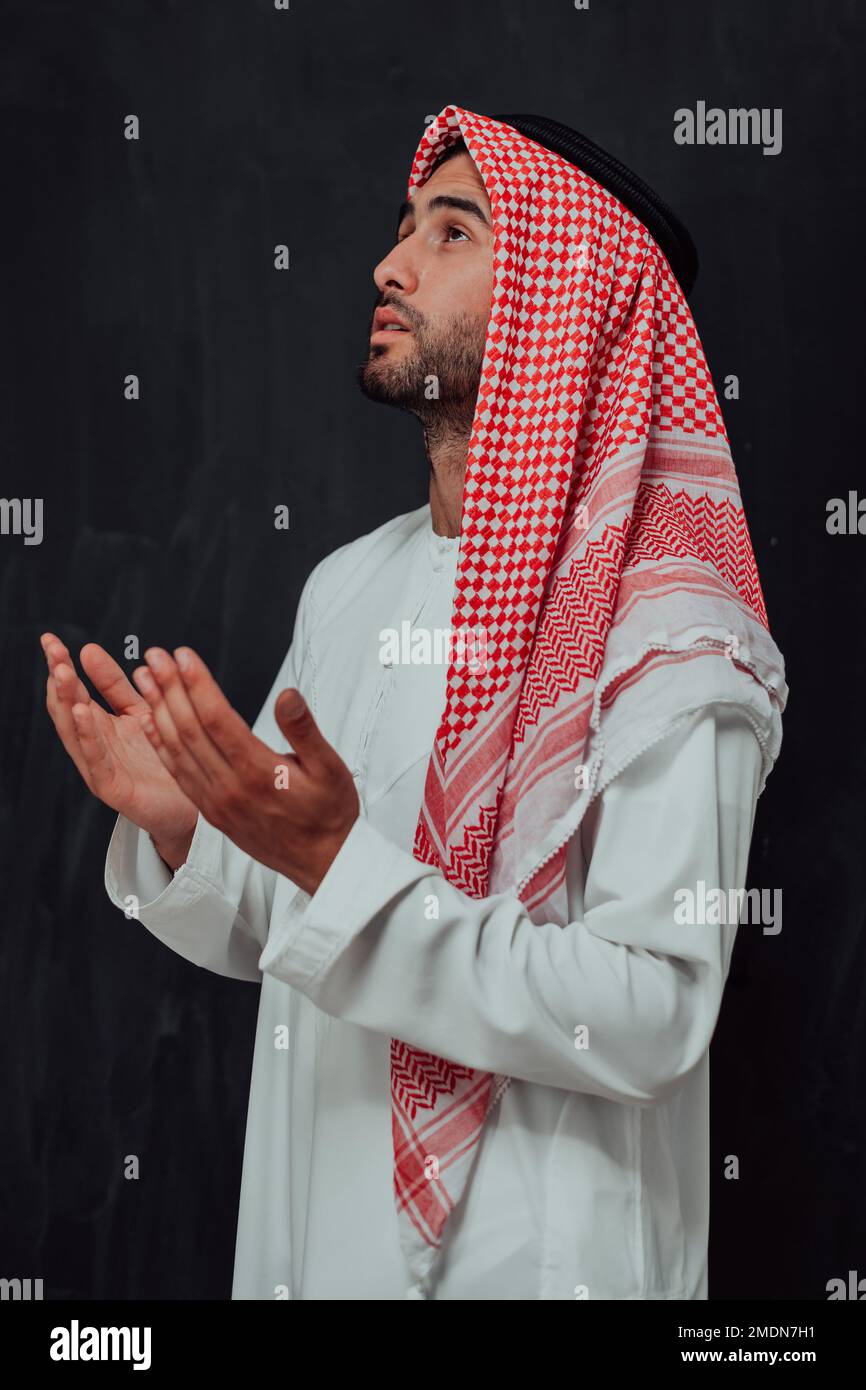 Arabian man in traditional clothes making traditional prayer to God ...
