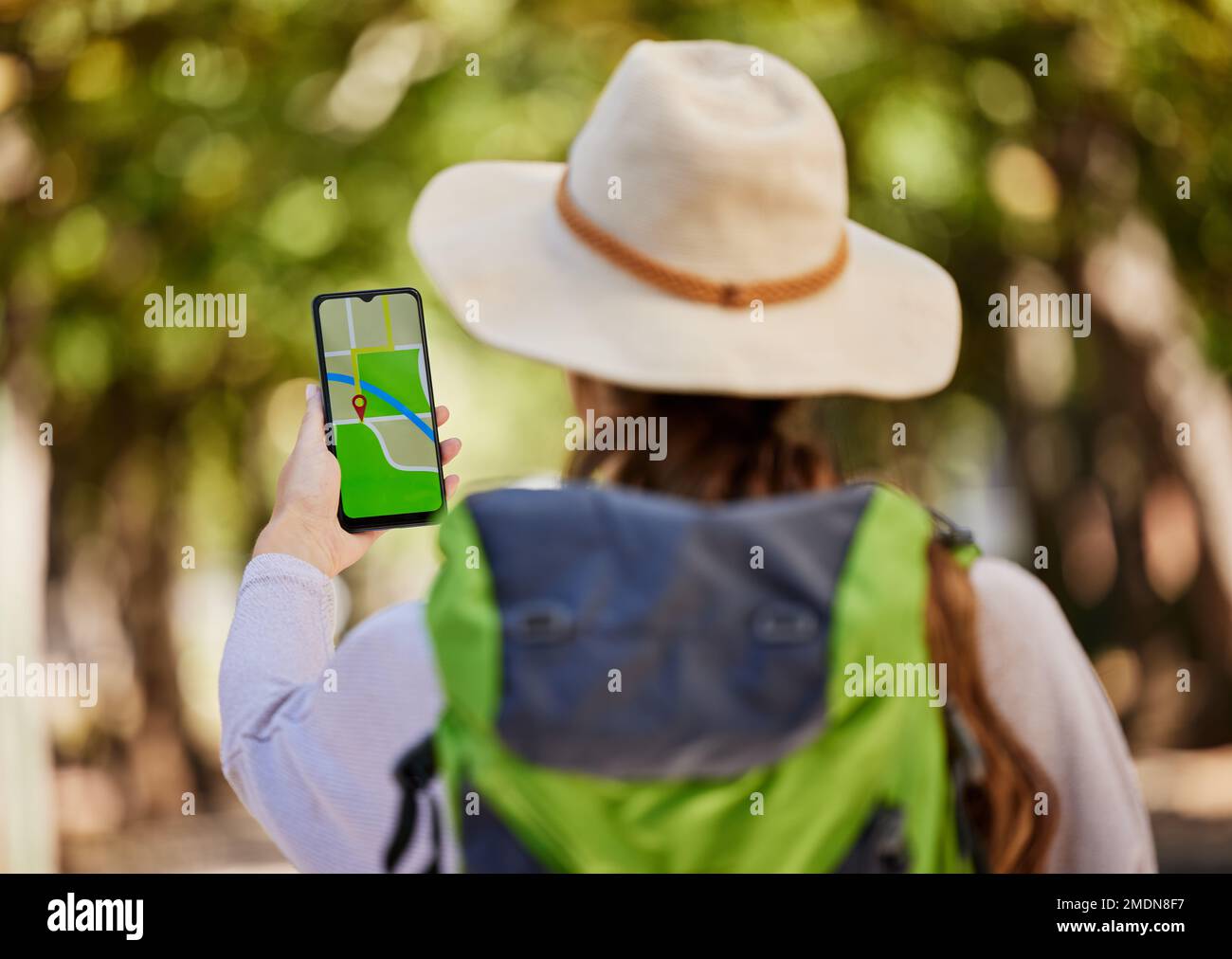 GPS, direction and woman hiking in a forest for exercise, adventure or ...