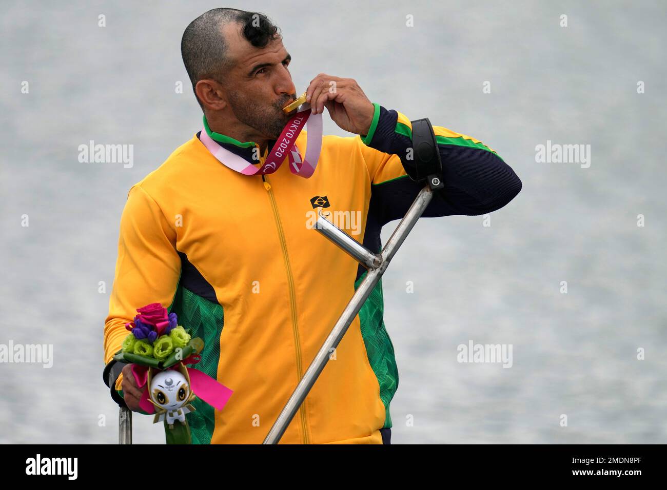Brazil's Fernando Rufino de Paulo bites his gold medal in the awarding ...