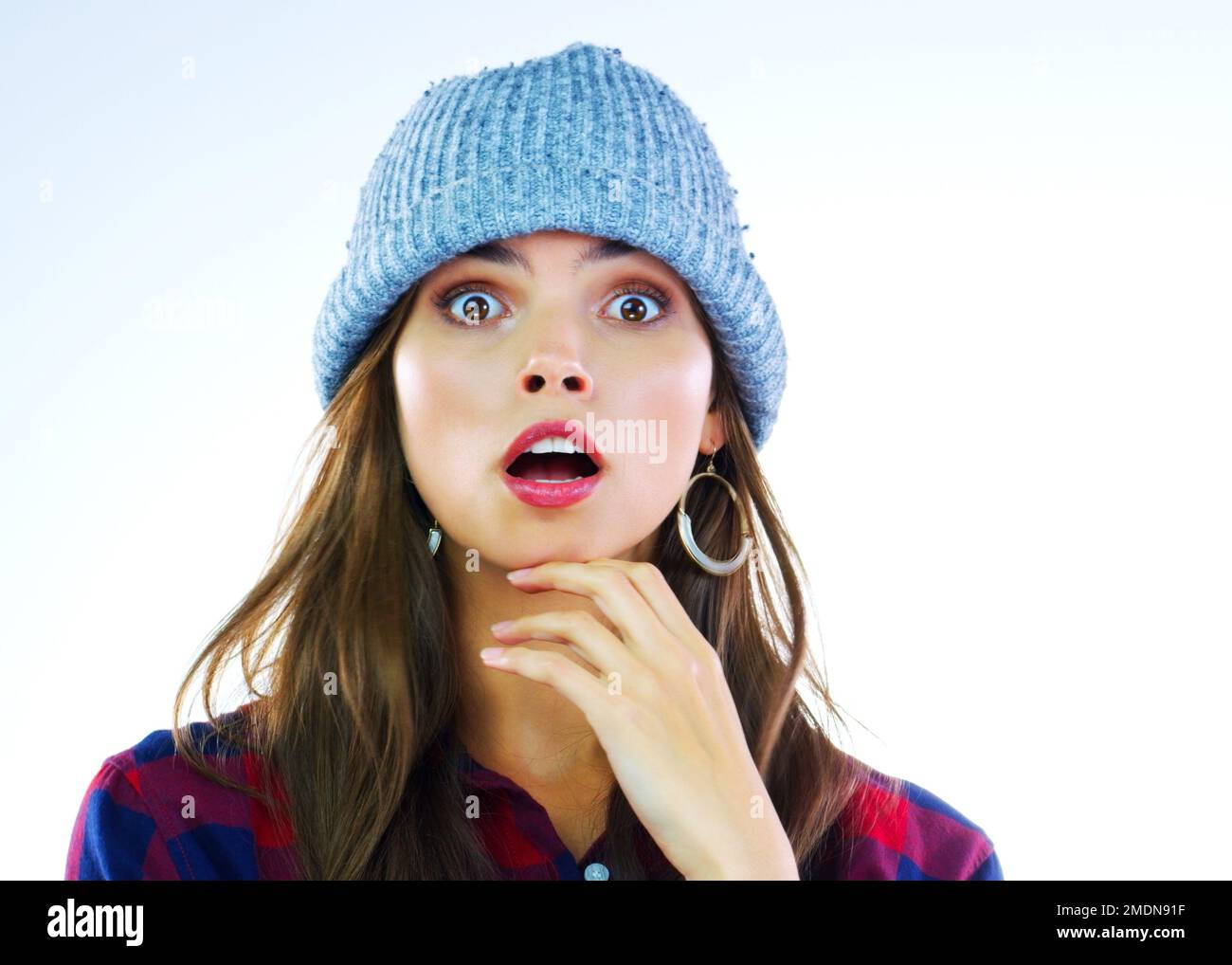 I cant believe it. Studio shot of a beautiful young woman gasping ...