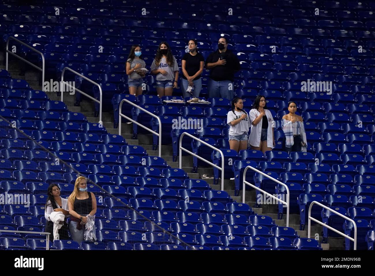 Baseball fans stand during the singing of the National Anthem before ...
