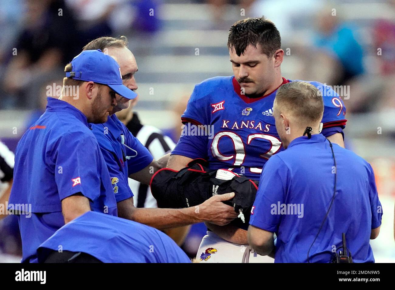 Kansas defensive lineman Sam Burt (93) is helped off the field after an ...