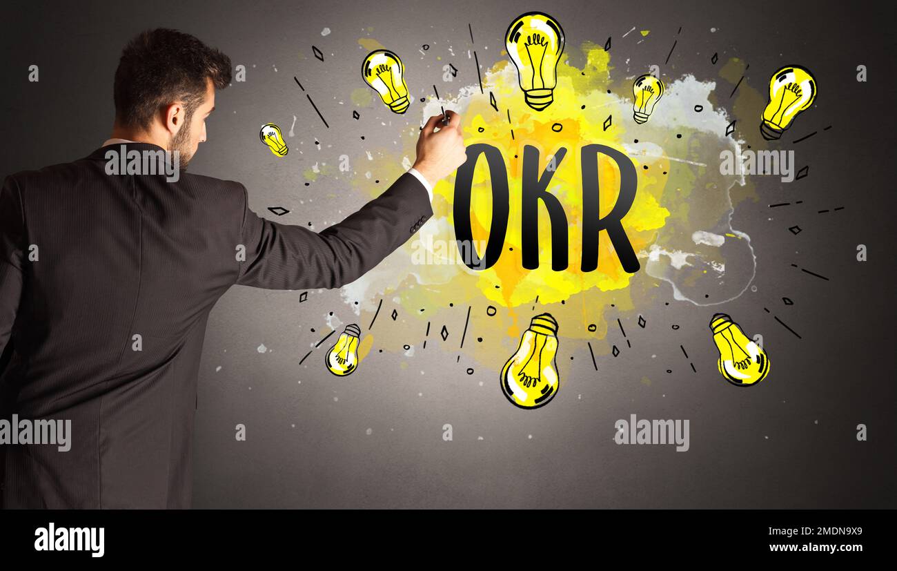 man drawing colorful light bulb Stock Photo - Alamy