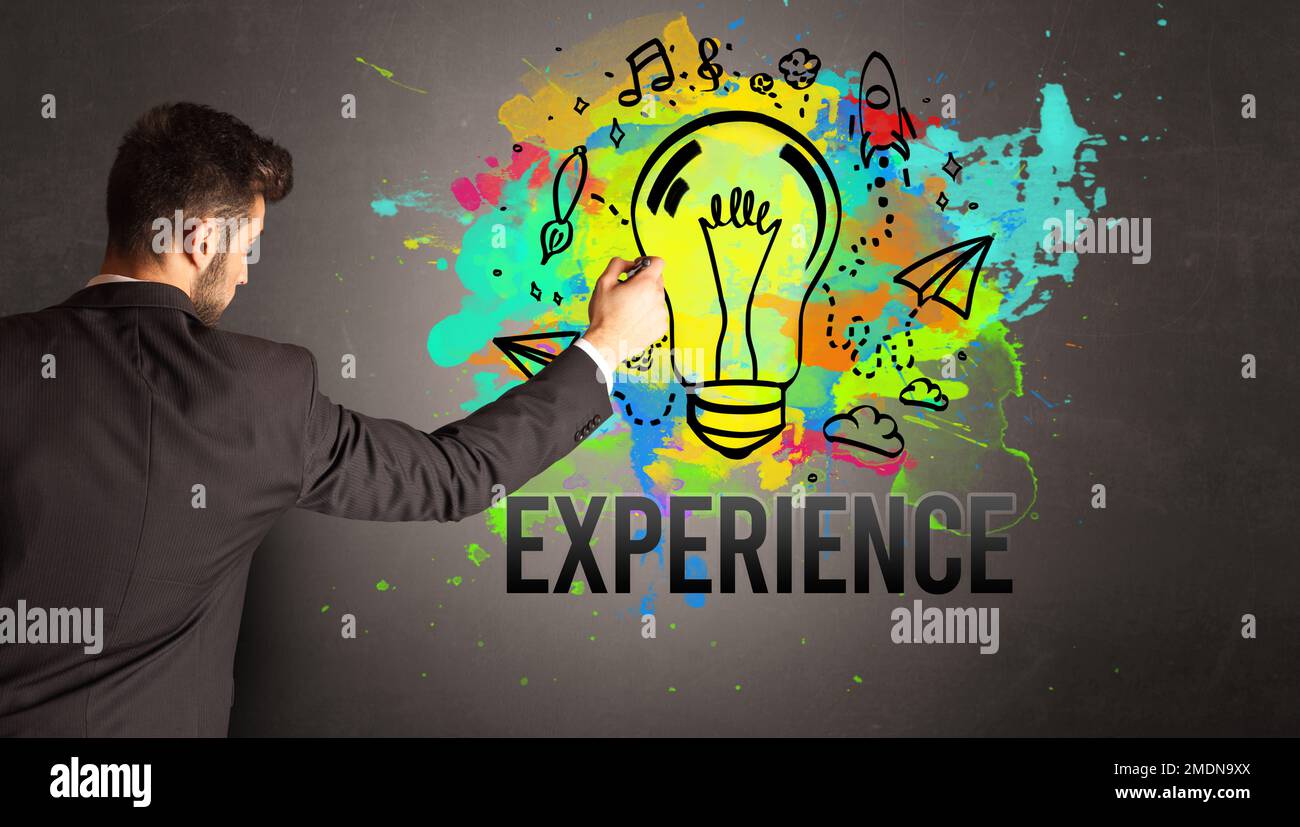 businessman drawing colorful light bulb Stock Photo - Alamy