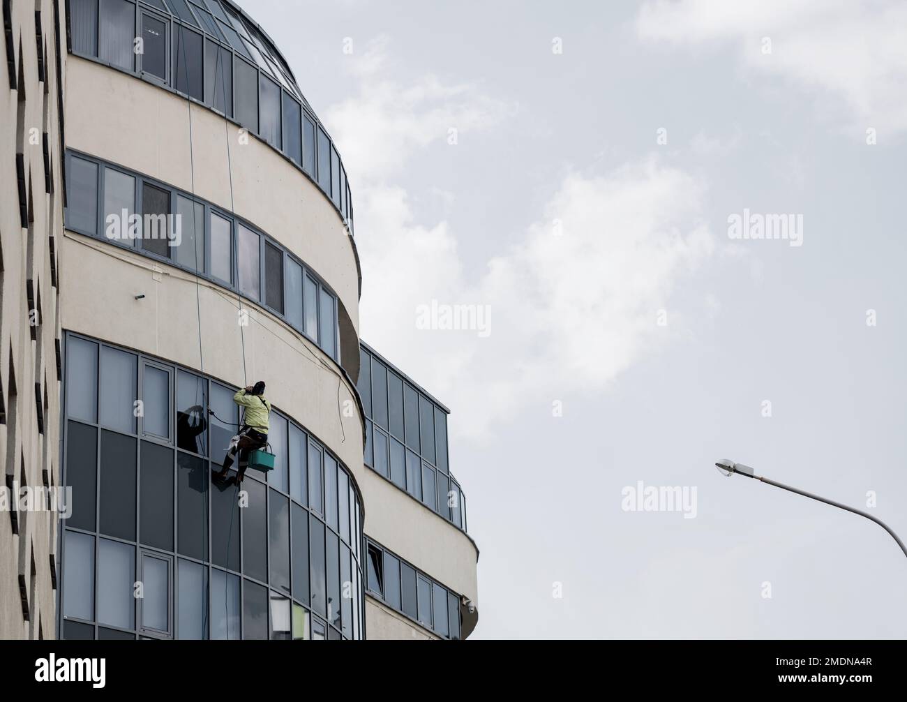 window washing. industrial mountaineering. work at a height. climber on ...