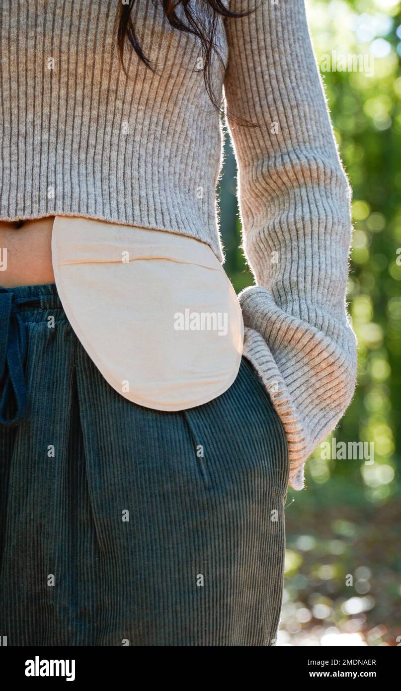 abdomen in nature with an ostomy bag in the belly. fashion in a person ...