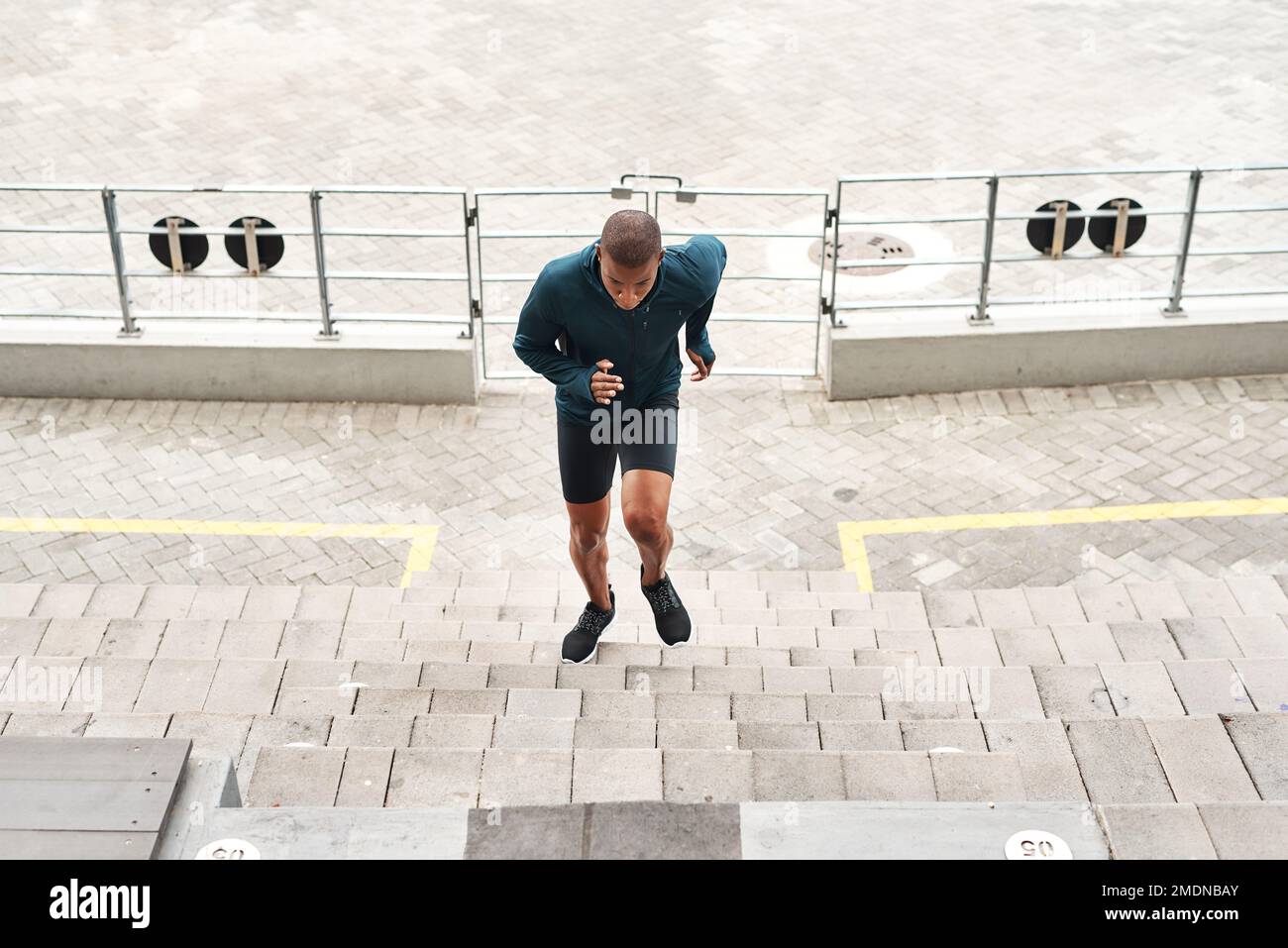 Working those quads. Full length shot of a handsome young athlete ...