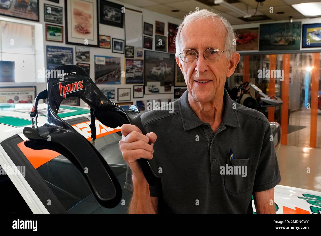 Jim Downing poses with the HANS (Head And Neck Support) device he co ...