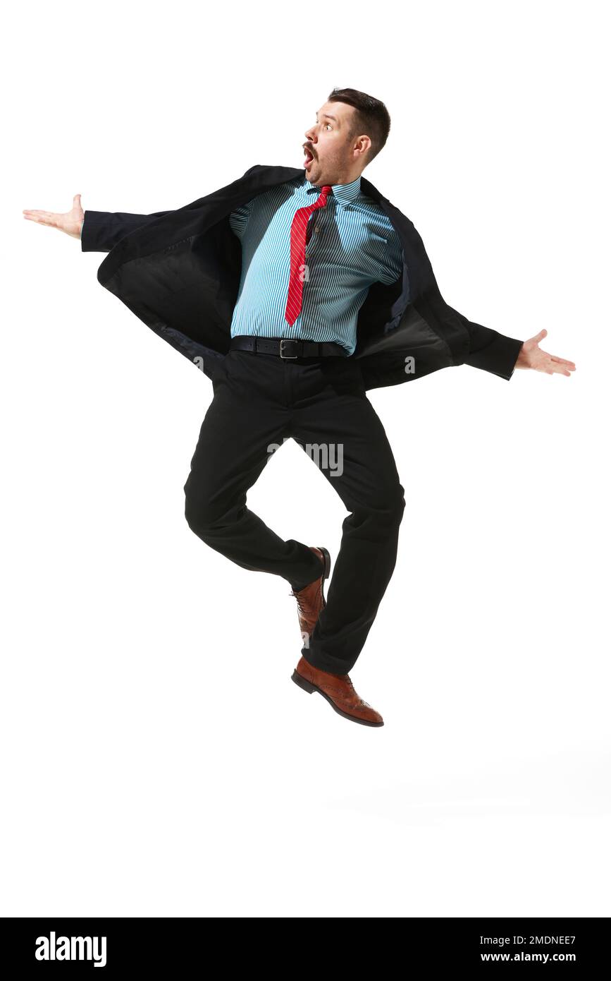 Businessman in a suit with surprised, shocked face jumping over white ...