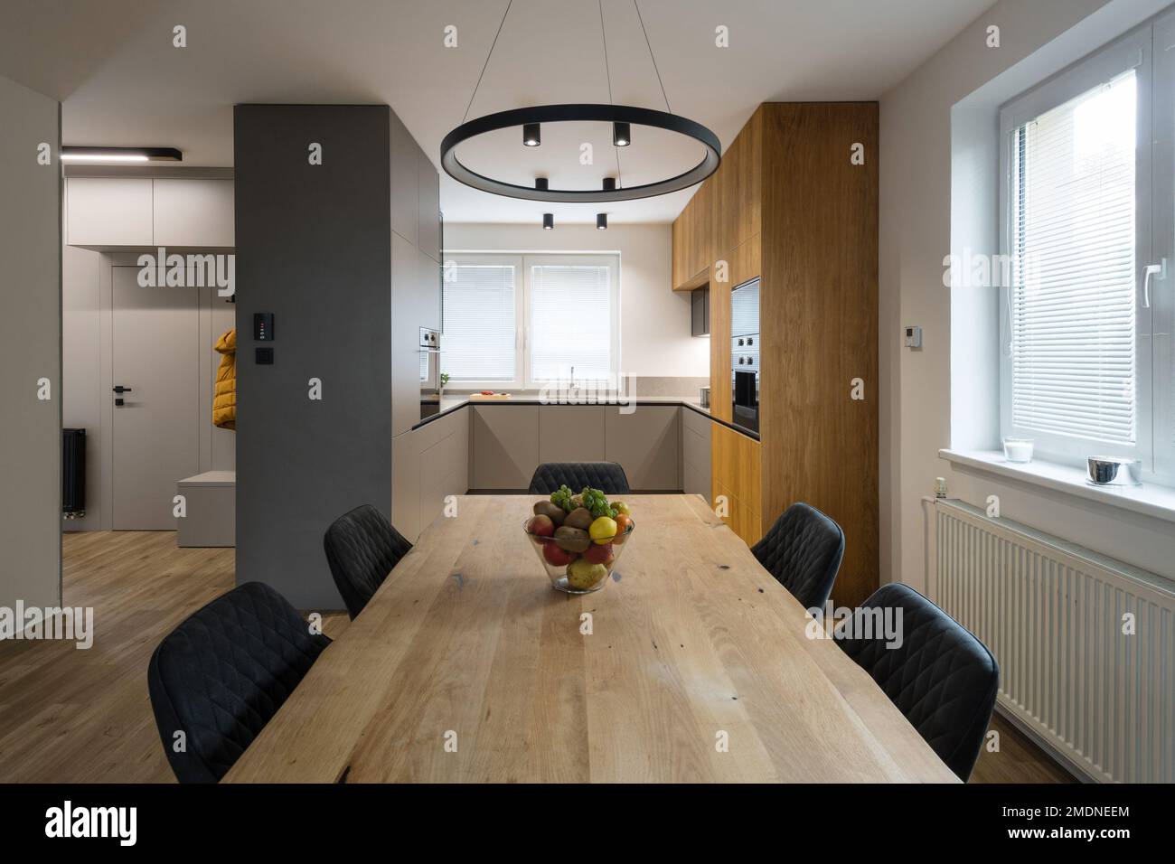 Modern kitchen with built in appliances and dining table Stock Photo ...