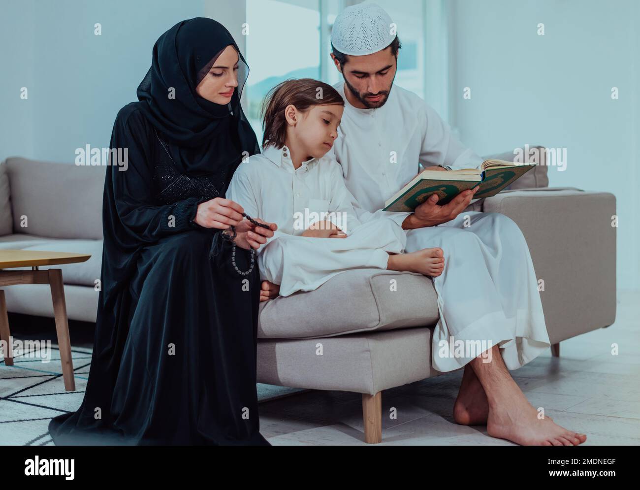 Happy Muslim family enjoying the holy month of Ramadan while praying ...