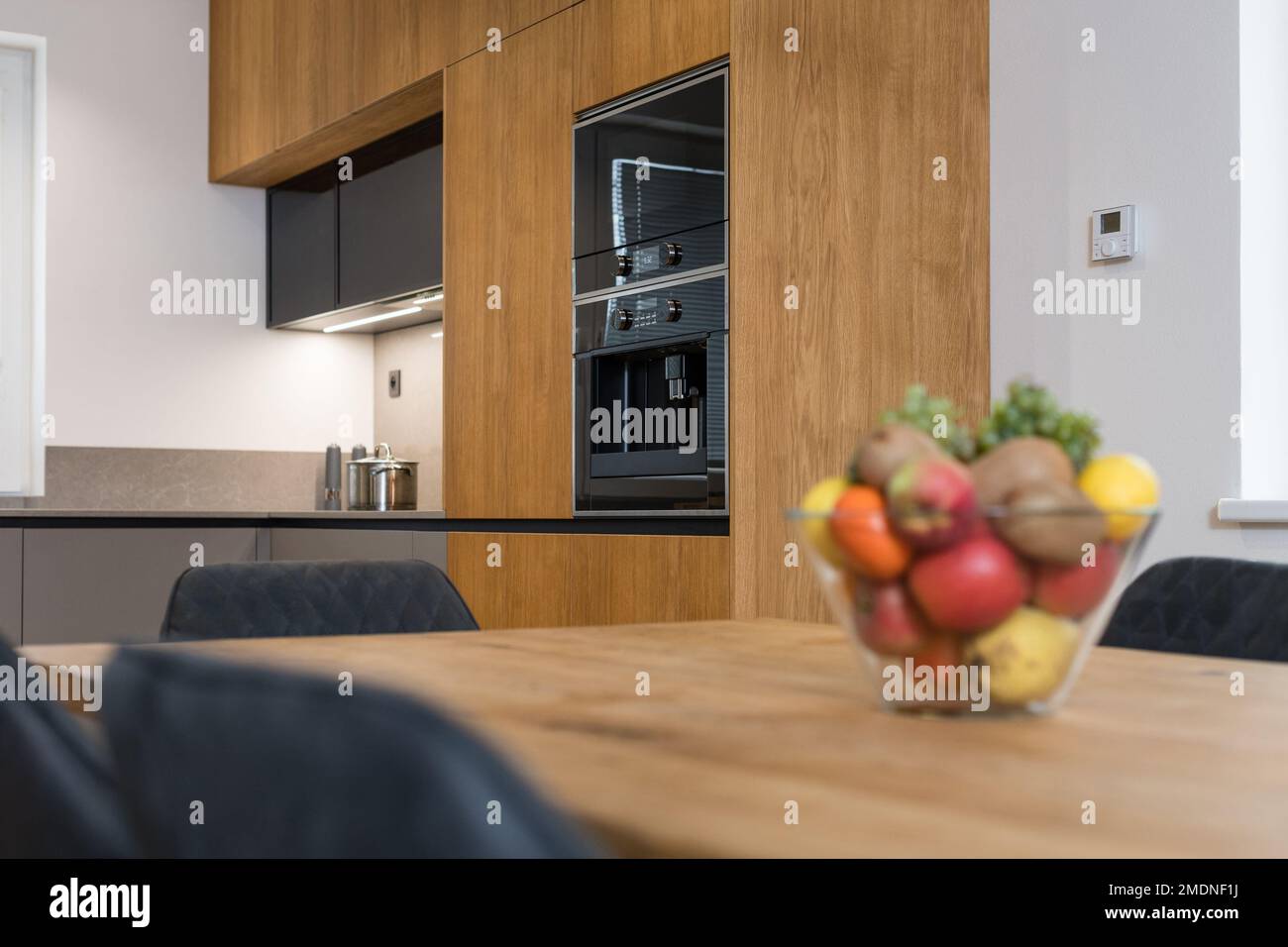 Modern kitchen with built in appliances and dining table Stock Photo ...