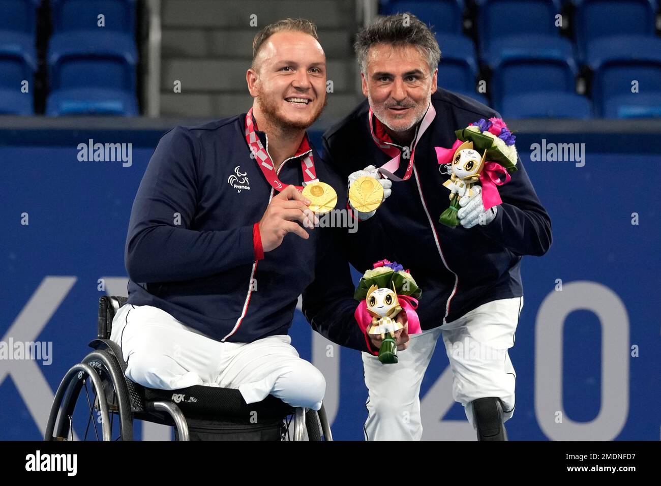 France's Stephane Houdet, right, and Nicolas Peifer pose with the gold ...