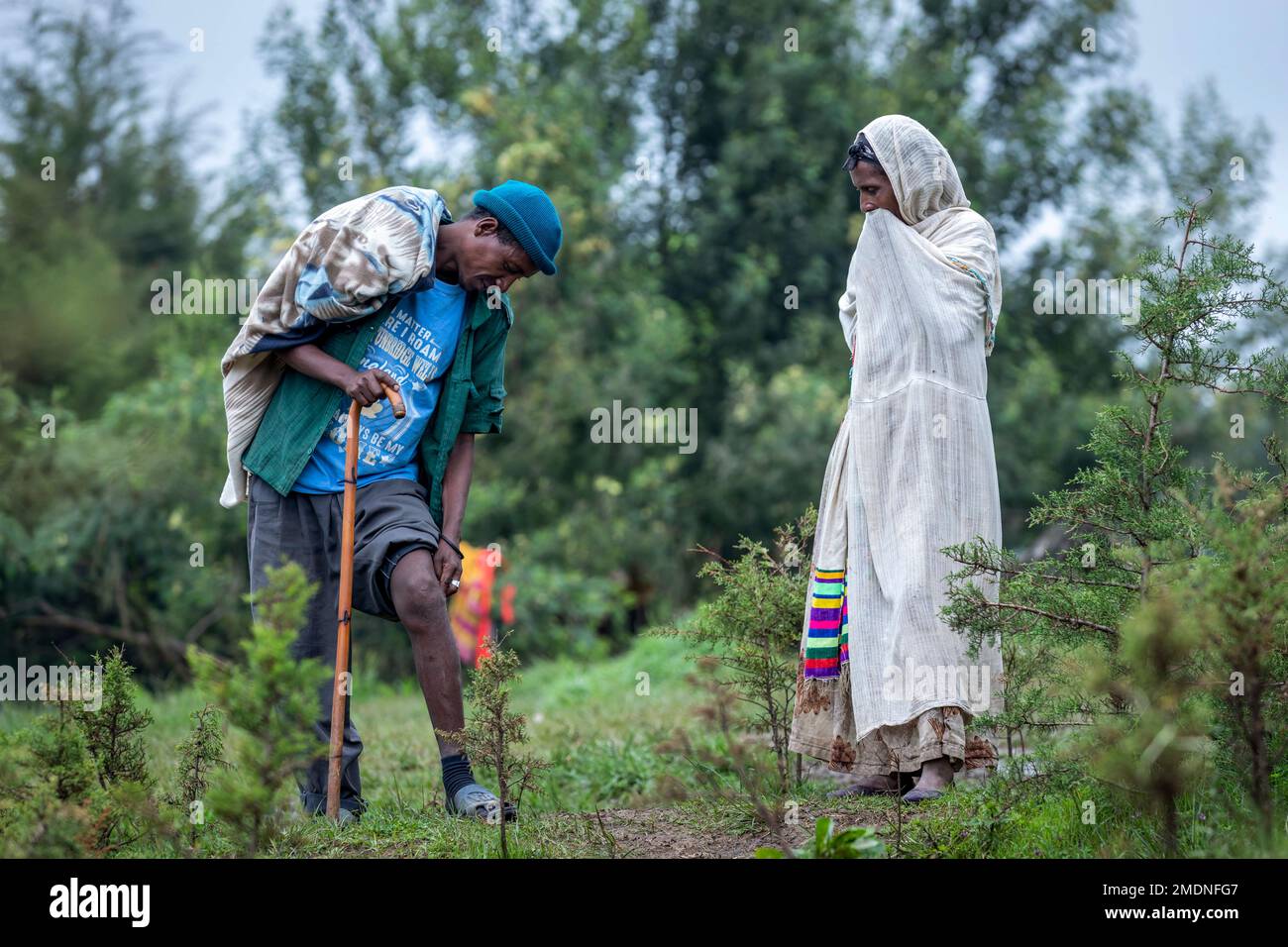 Militia fighter Abebaw Adugna, left, shows his wound to a woman from ...