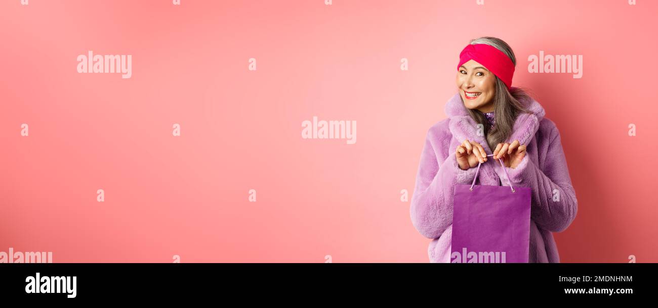 Shopping and fashion concept. Fashionable gradmother bought present and ...