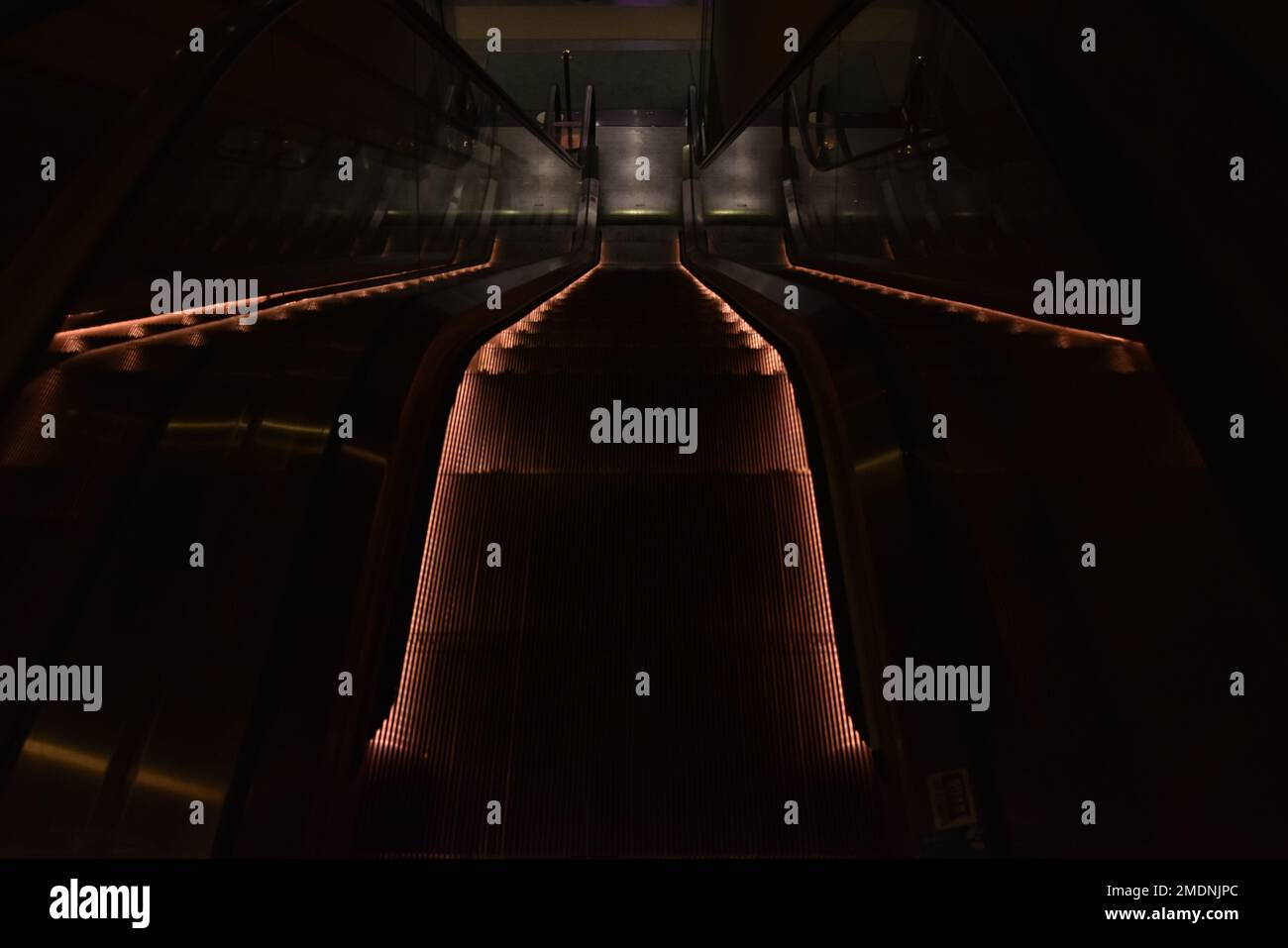 A low angle shot of an escalator with dim lights Stock Photo - Alamy