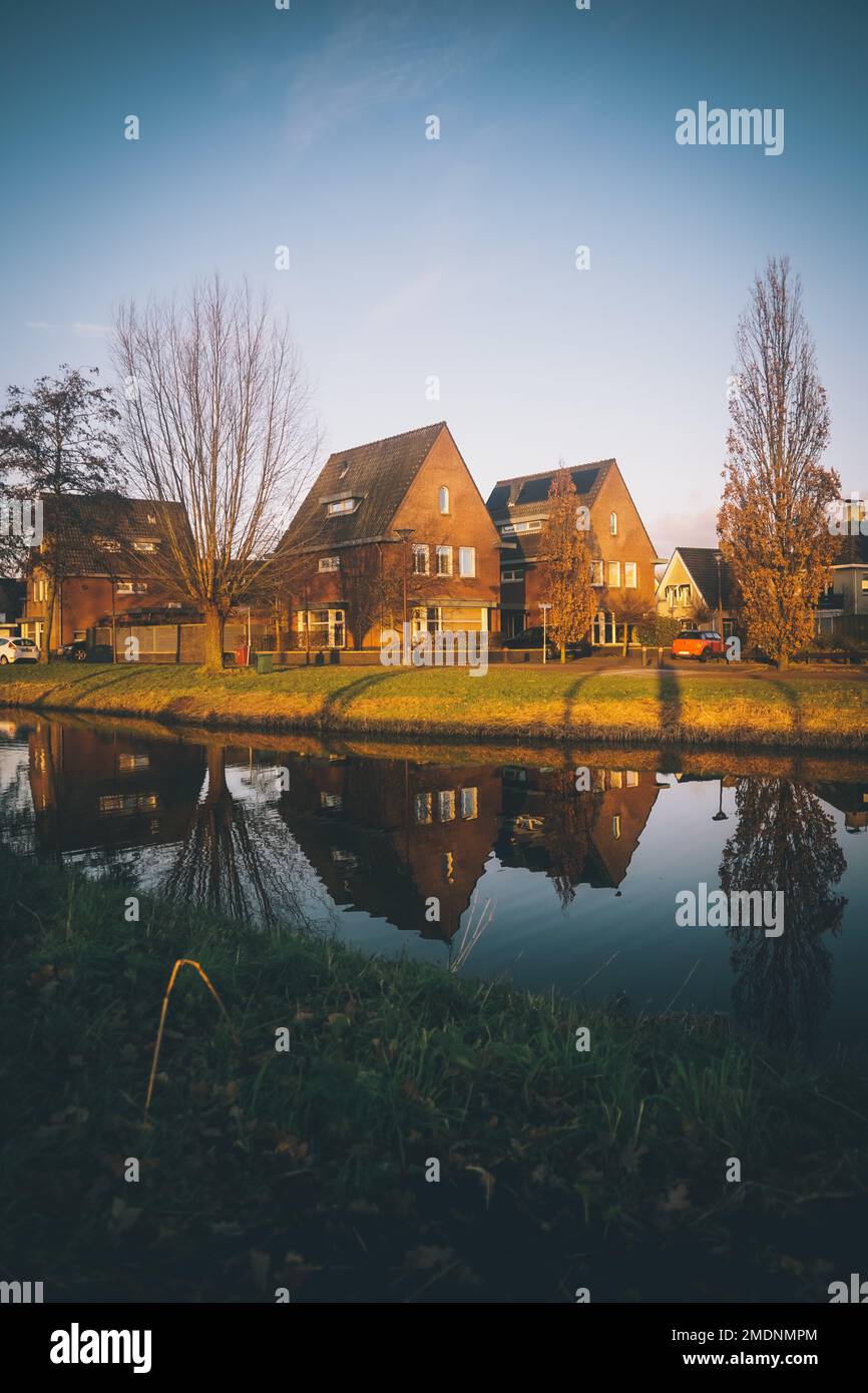 The reflection of village houses on a small lake in the neighborhood in ...
