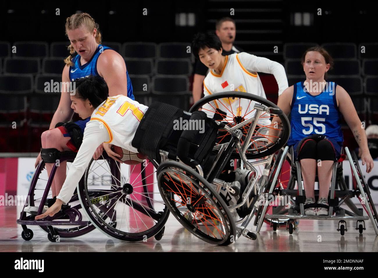 China's Zhang Tonglei (7) falls as she collides with United States ...