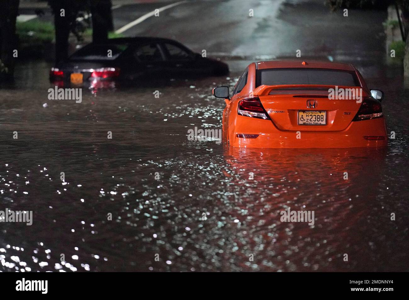 Abandoned cars sit in high water on a road in Lodi, N.J., Thursday ...