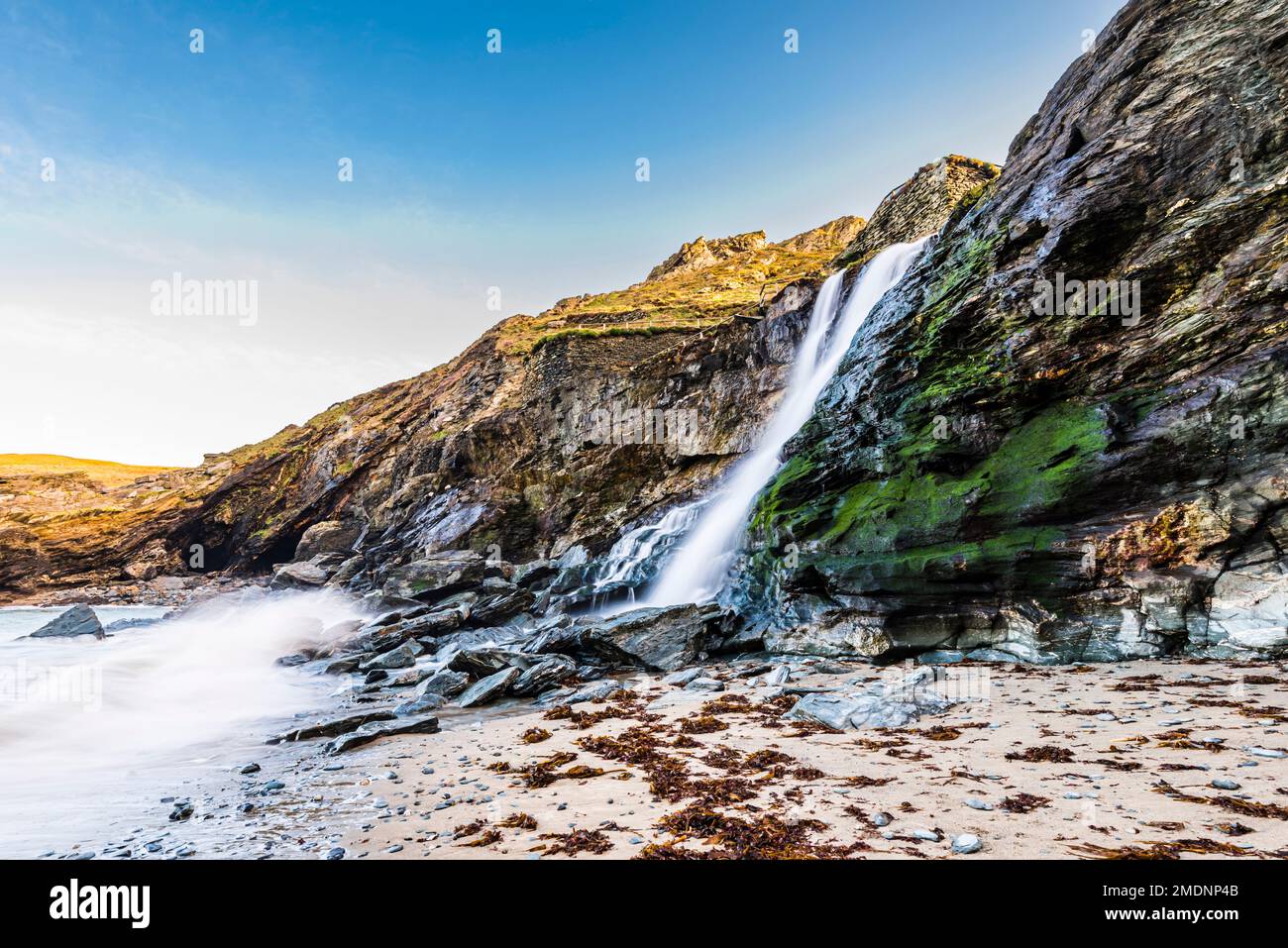 Long exposure of the waterfall and surf on Tintagel Haven beach ...