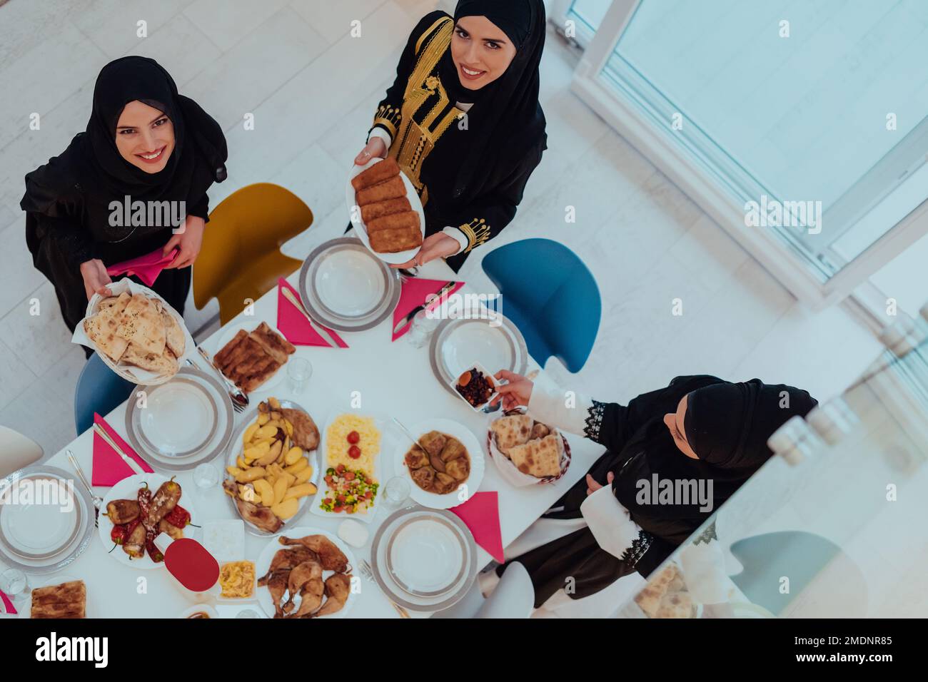 Top view of Muslim family having Iftar dinner drinking water to break ...