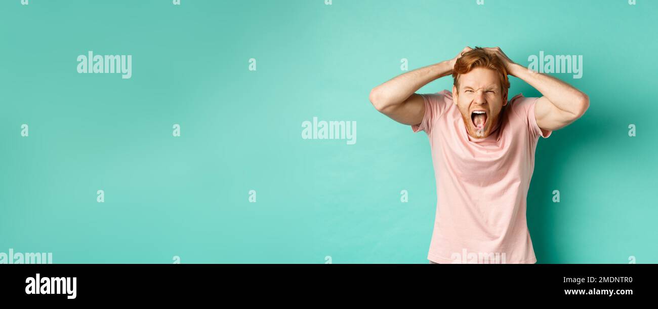 Angry redhead man screaming and ripping hair out of head, yelling and ...